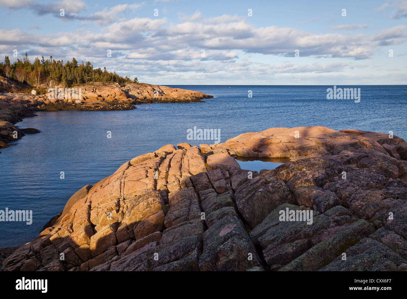 The sun sets on the rocky seashore and the intertidal zone of the St ...