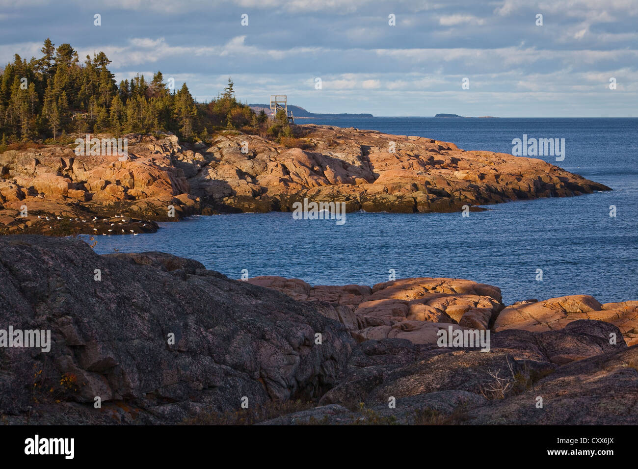 The sun sets on the rocky seashore and the intertidal zone of the St ...