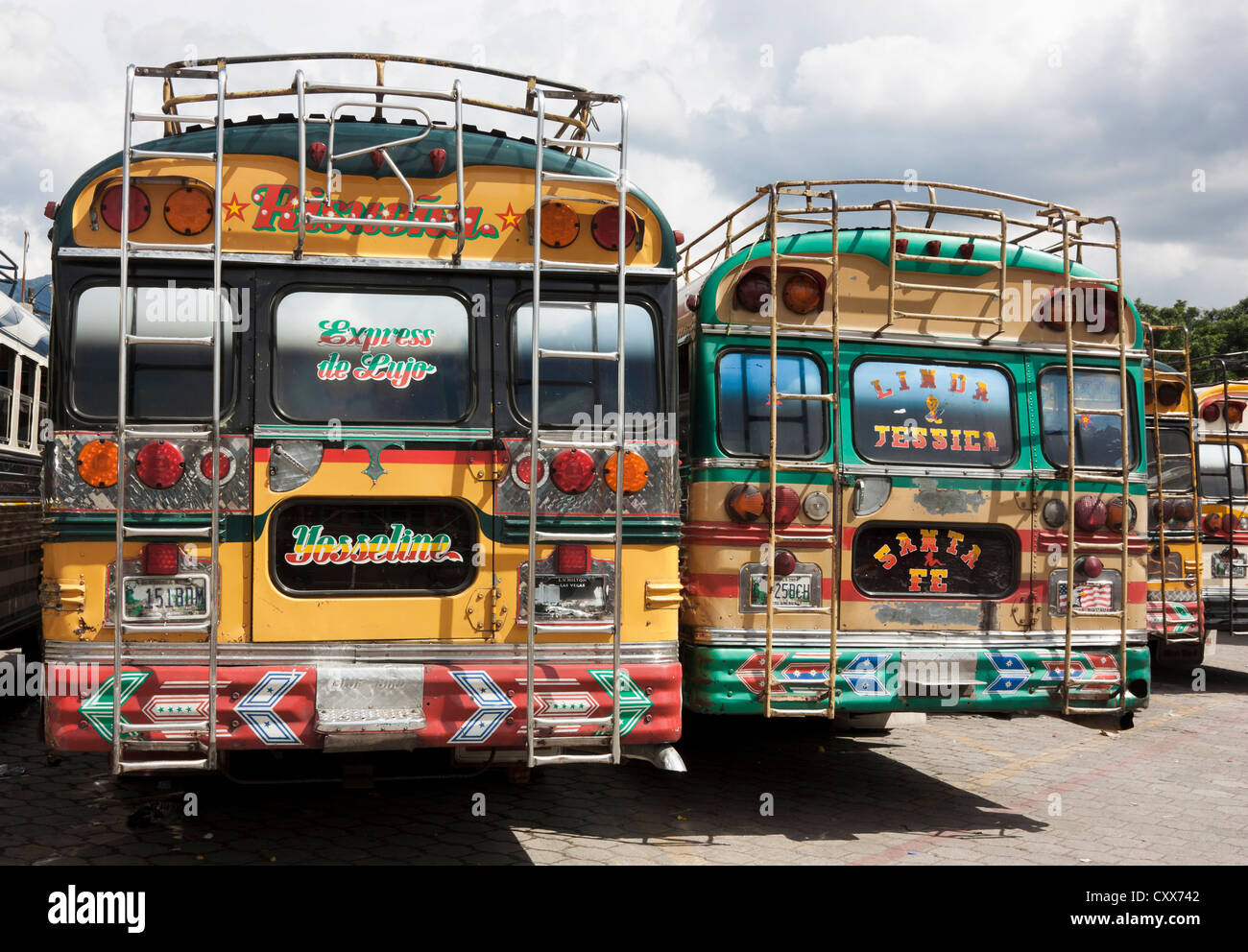 Brightly decorated local buses (chicken buses) at Antigua city bus ...