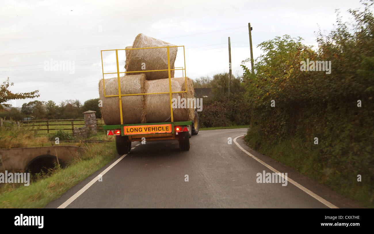 Wayward farm trailer in a narrow country lane Stock Photo - Alamy