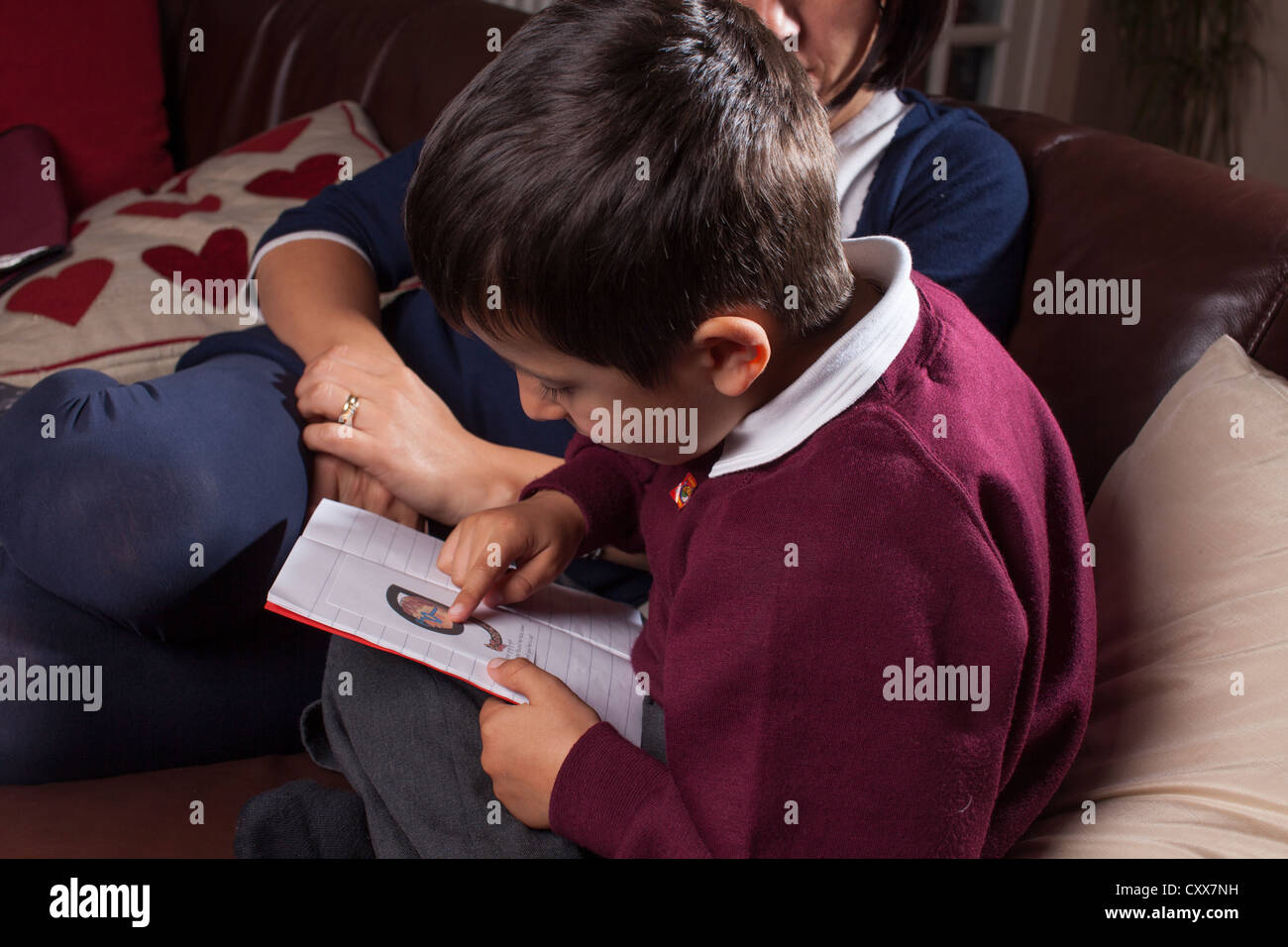 Child in school uniform learning the alphabet Stock Photo - Alamy
