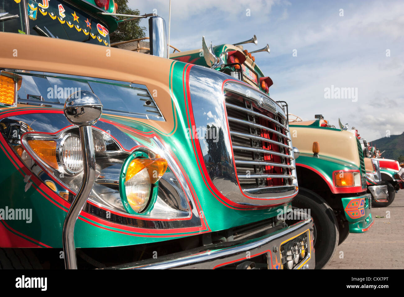 Brightly decorated local buses (chicken buses) at Antigua city bus ...