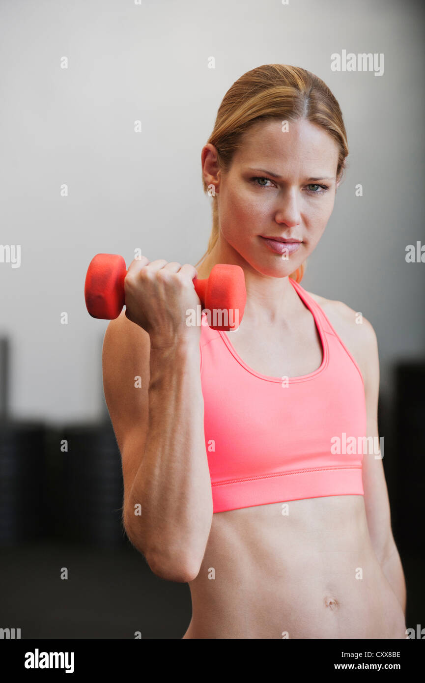 Caucasian woman using dumbbell Stock Photo - Alamy
