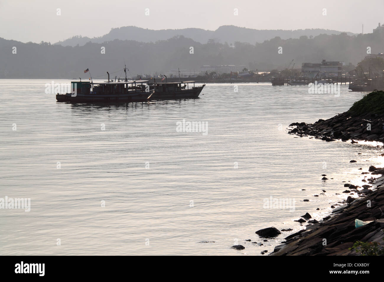 Fishing boats on Sulu Sea at dusk, Sandakan waterfront, Sabah, Borneo ...