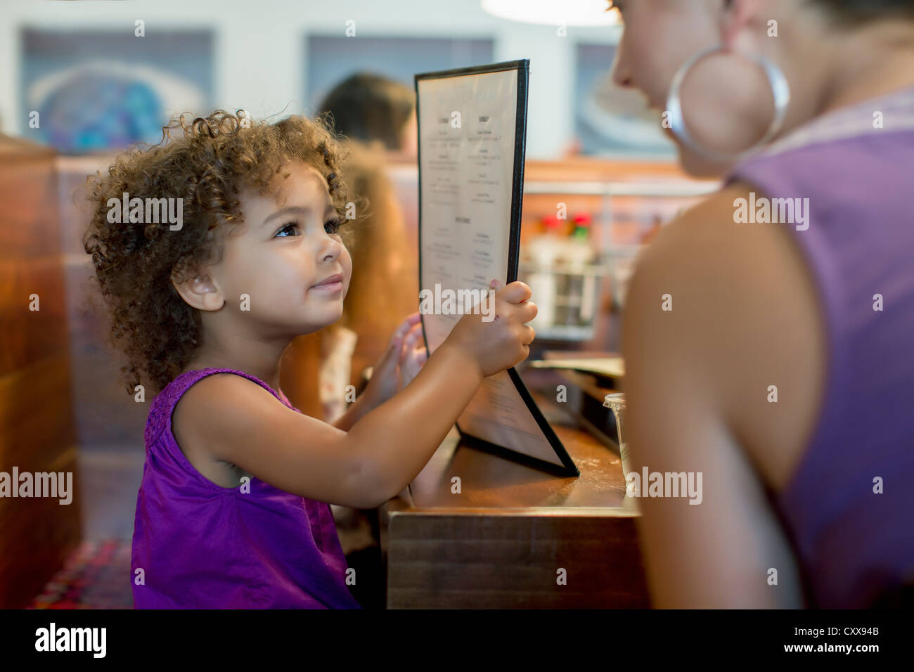 Mother and daughter ordering in restaurant Stock Photo - Alamy