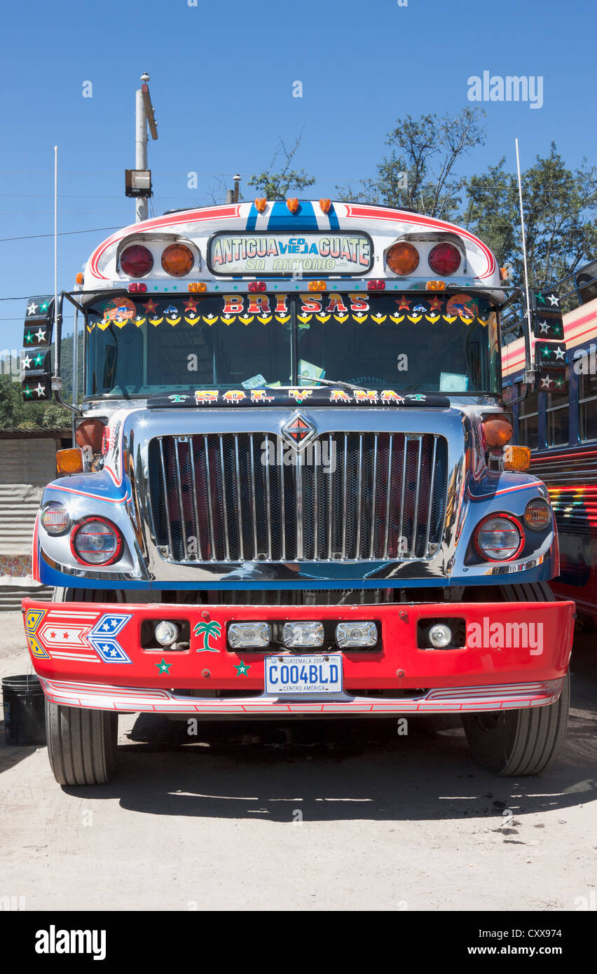 Brightly decorated local buses (chicken buses) at Antigua city bus ...