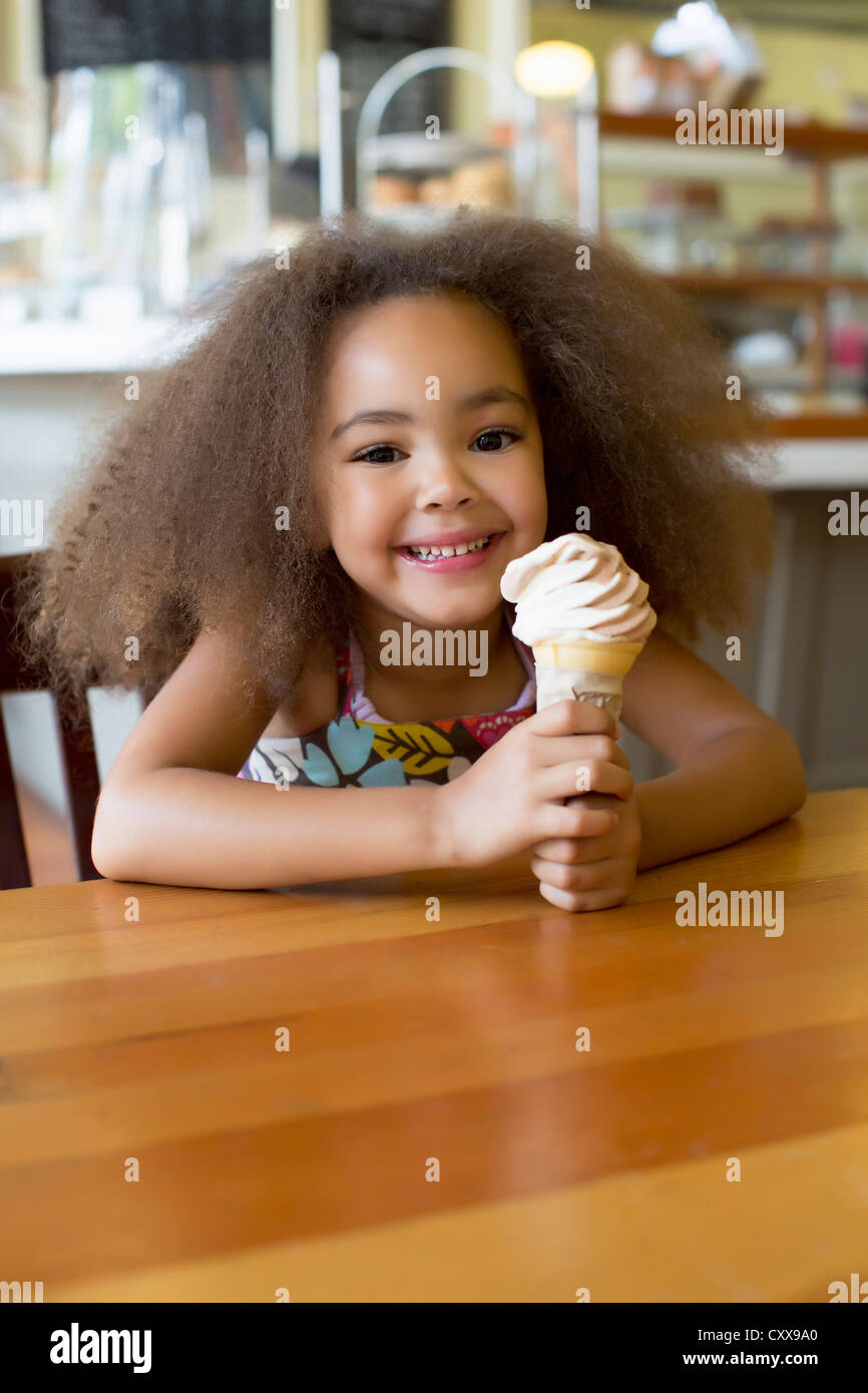 Mixed race girl eating ice cream cone Stock Photo - Alamy