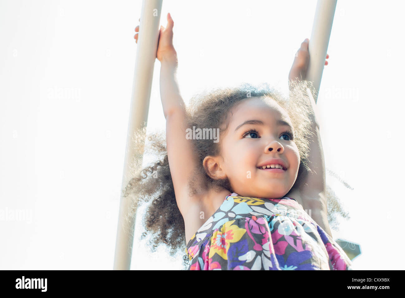 Hanging from playground bars hi-res stock photography and images - Alamy
