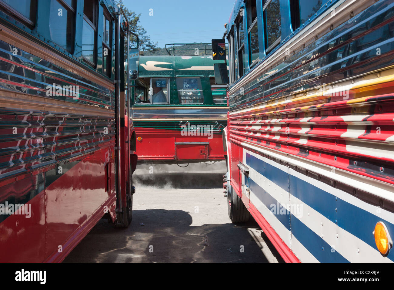 Brightly decorated local buses (chicken buses) at Antigua city bus ...