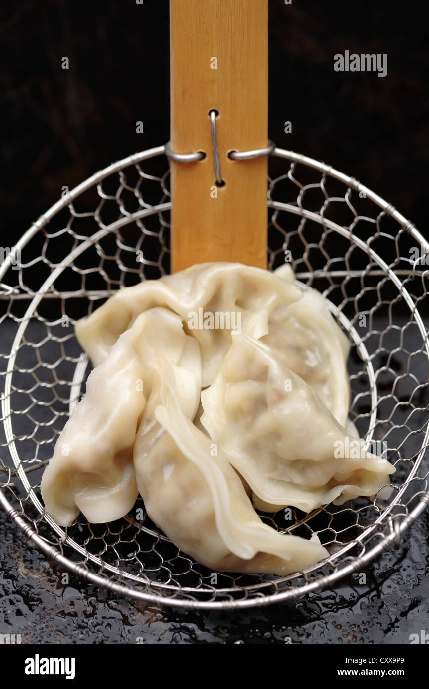Asian dumplings in strainer Stock Photo - Alamy