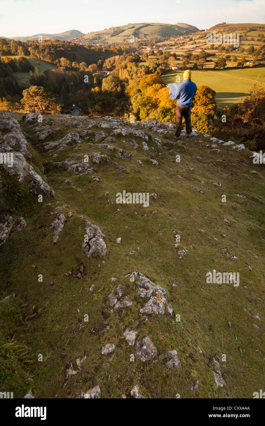 Hill walker overlooking the valley and hamlet of Loggerheads in ...