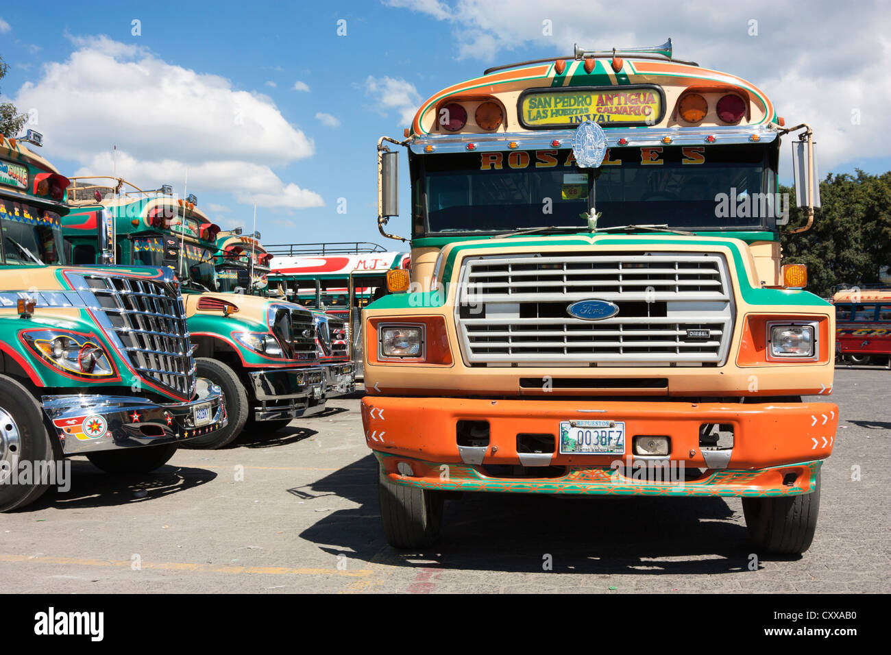 Brightly decorated local buses (chicken buses) at Antigua city bus ...