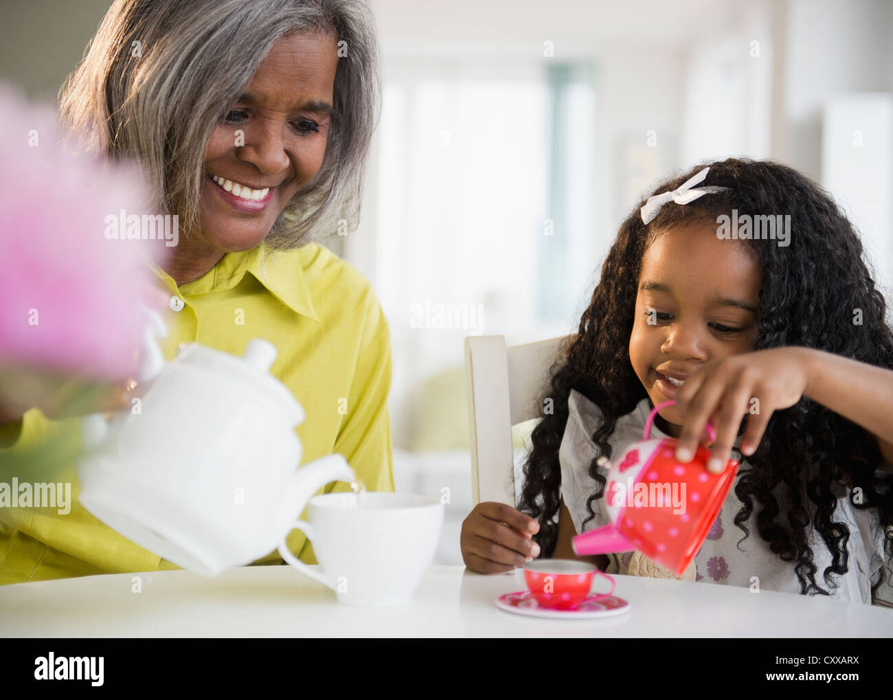 African American grandmother and granddaughter having tea party Stock ...