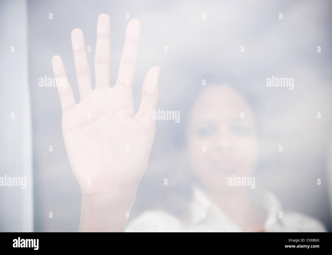 Cape Verdean woman putting hand on window Stock Photo - Alamy