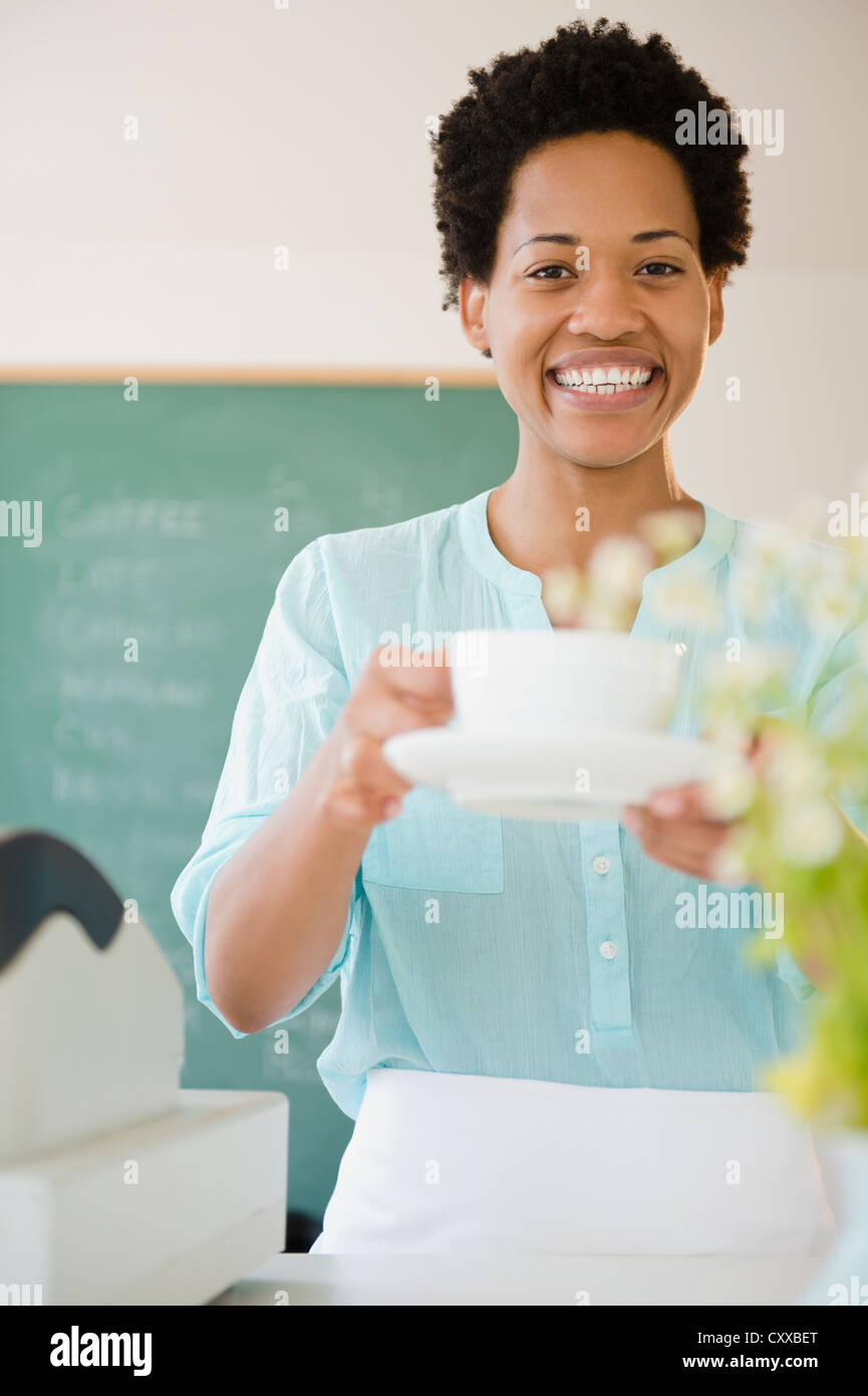 African American woman serving coffee Stock Photo - Alamy