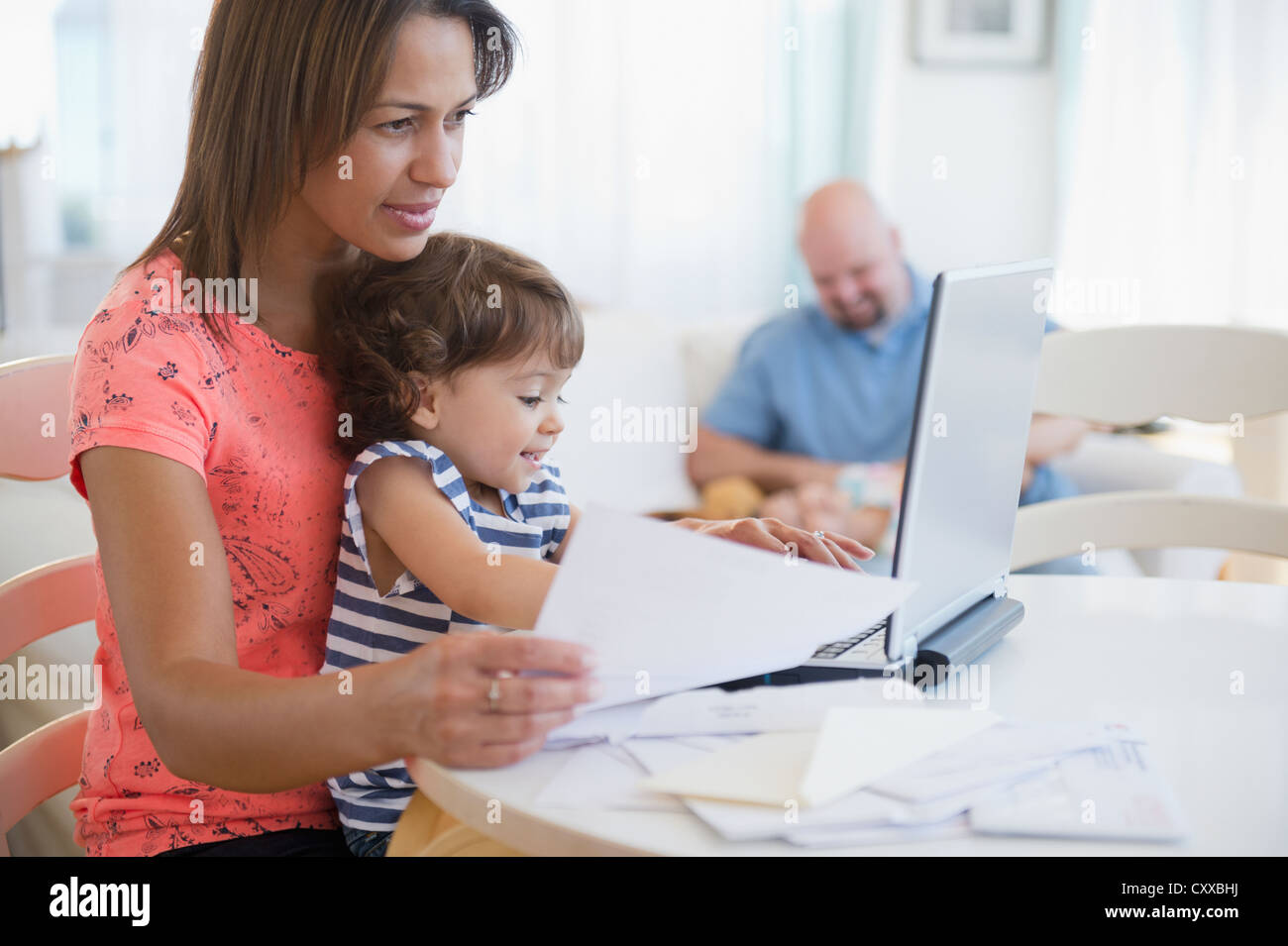 Mother working at computer with child on her lap Stock Photo - Alamy