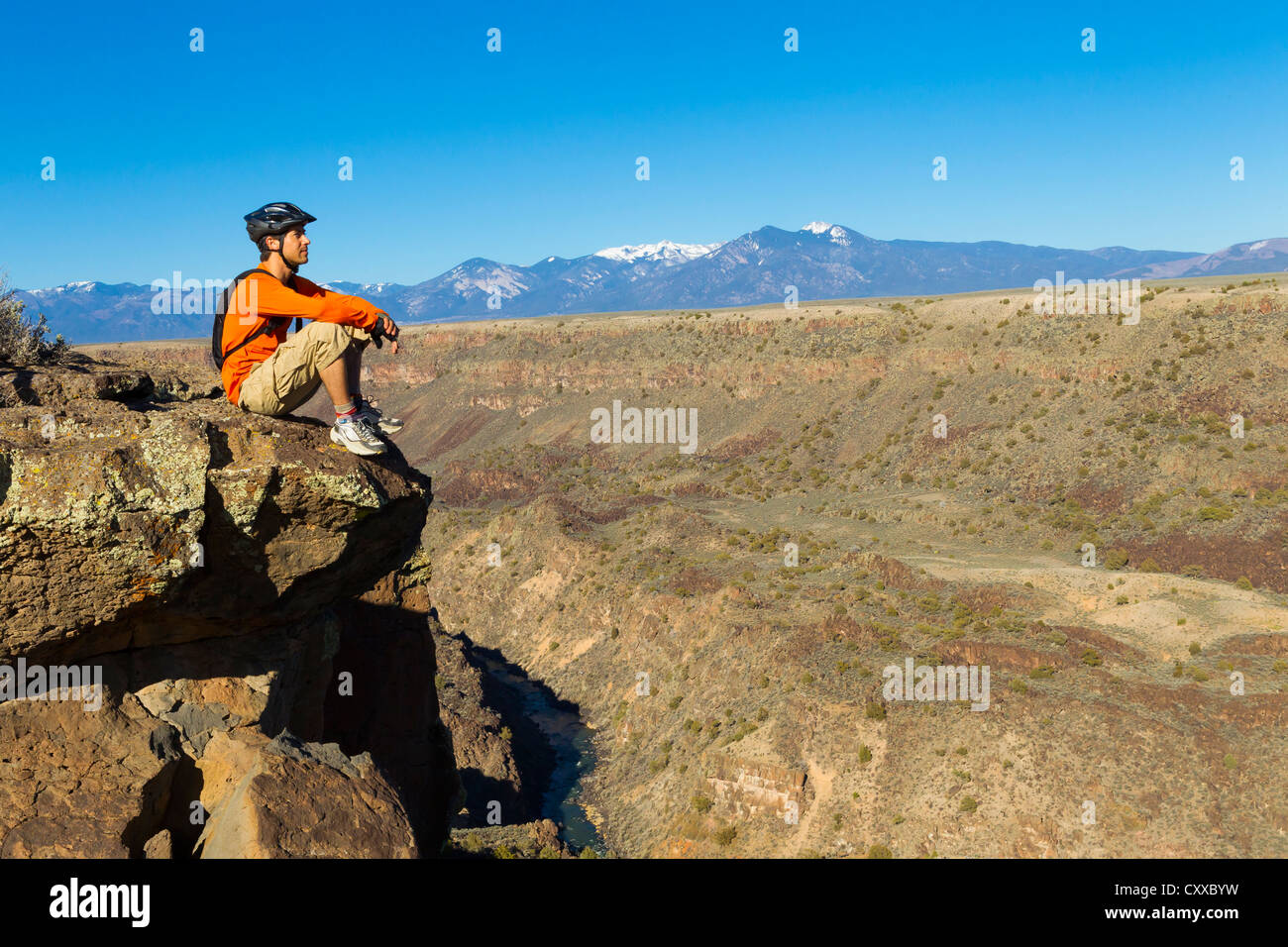 Man sitting on side cliff hi-res stock photography and images - Alamy