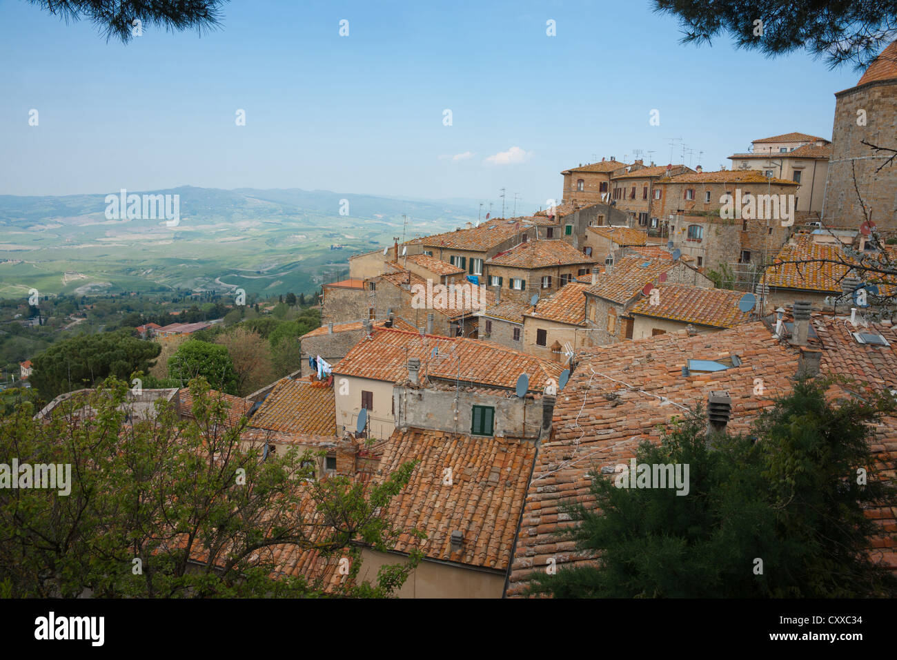 Landscape with terra cotta tiled roofs of the Italian hillside town of ...