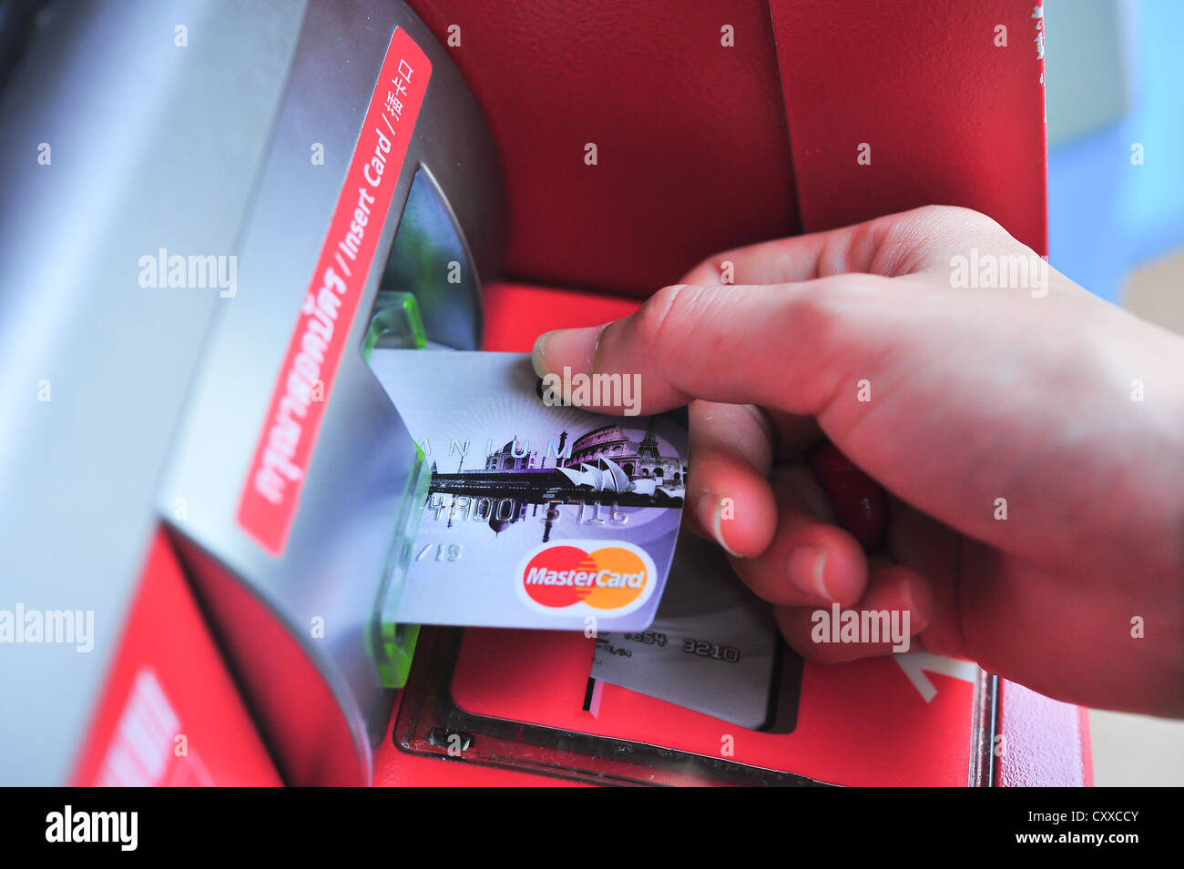 Female hand inserts a plastic card in the ATM Stock Photo - Alamy