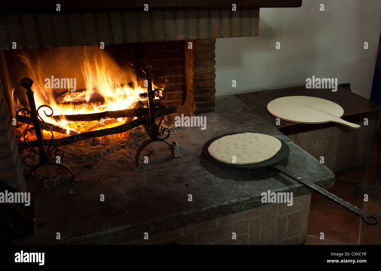 Cooking focaccia bread traditionally, in a fire Stock Photo - Alamy