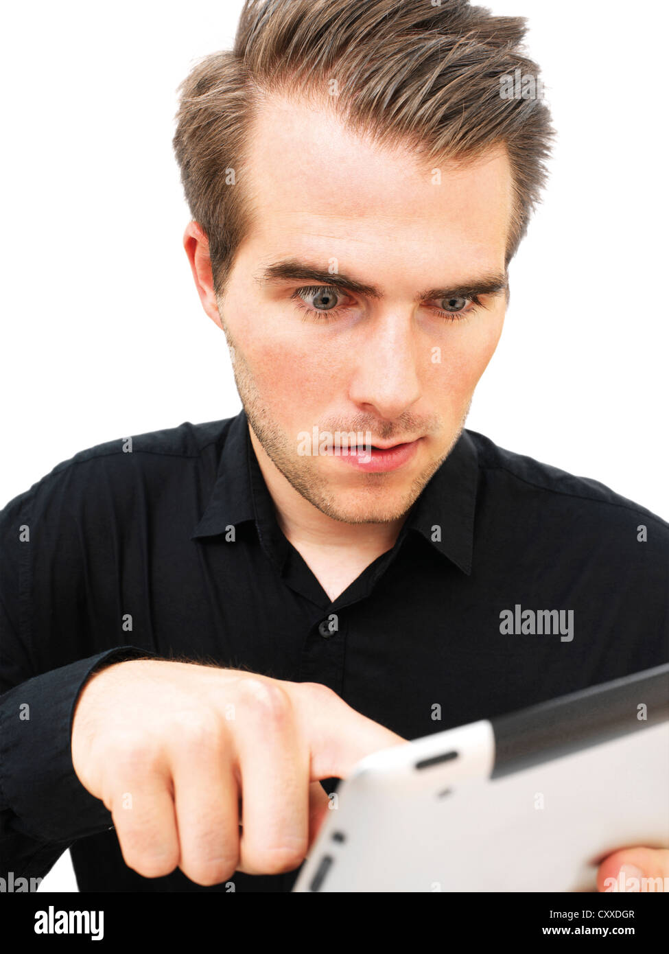 Young businessman working on an iPad, startled Stock Photo - Alamy