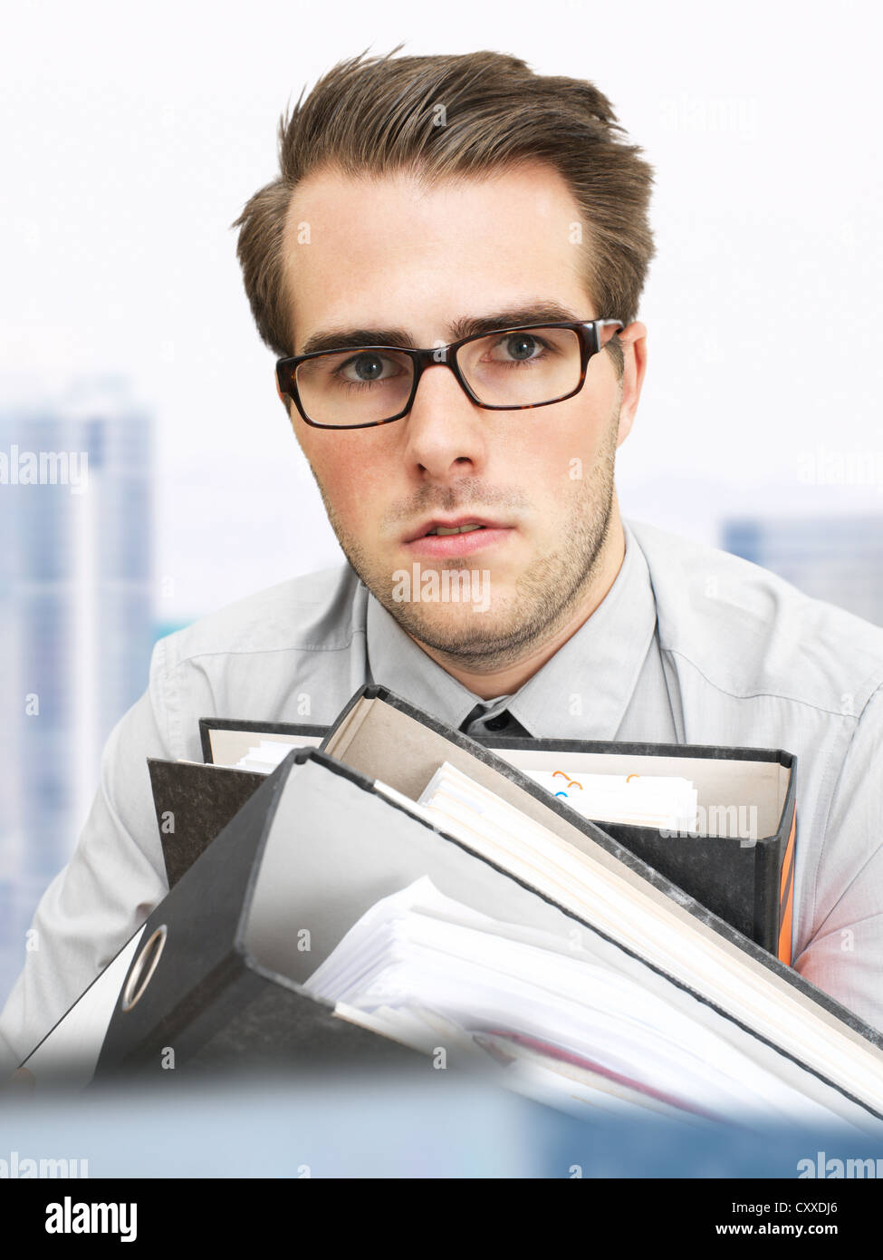 Young man carrying files portrait hi-res stock photography and images ...