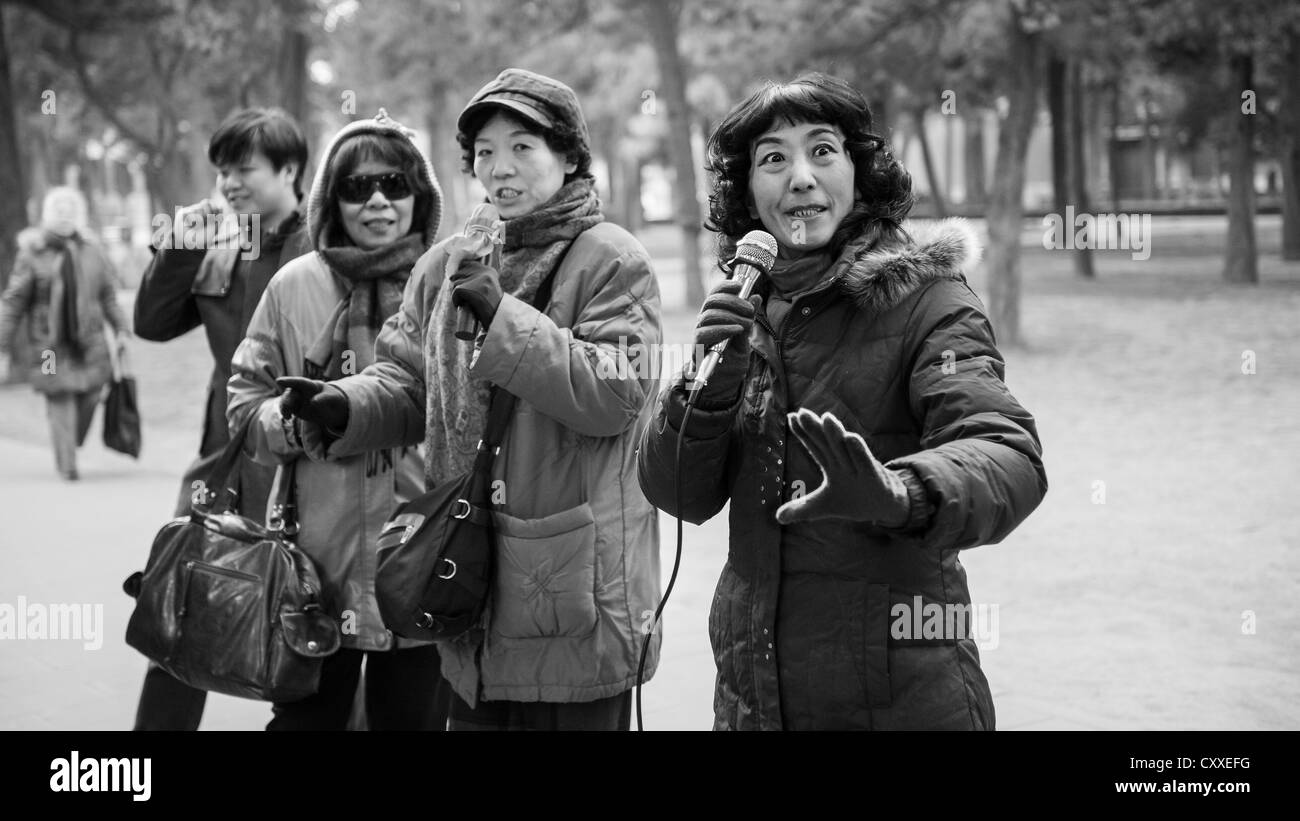 Jingshan Park, Beijing. People singing Beijing opera music in the park ...