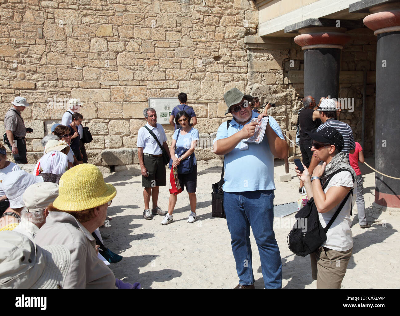 Tour guide speaking to visitors at the Minoan Temple at Knossos Crete ...