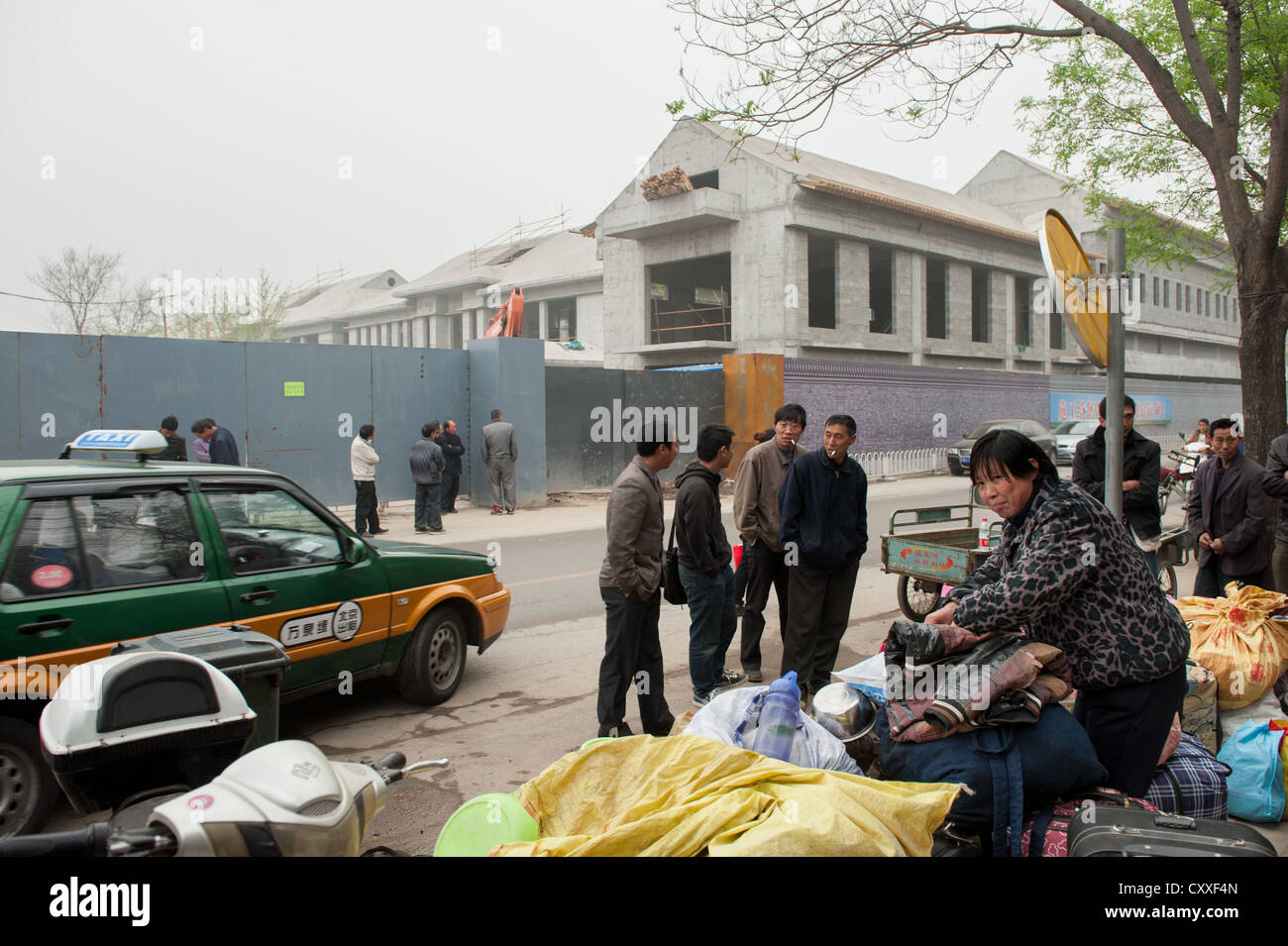 Beijing, China. Newly arrived migrant workers waiting for transport to ...