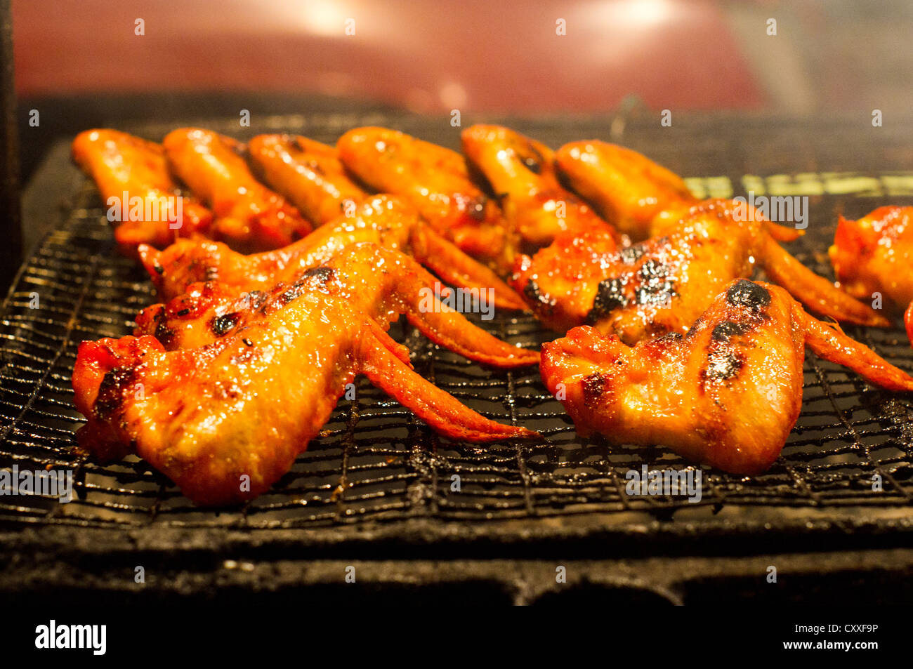 chicken wings are being grilled, street food Stock Photo - Alamy