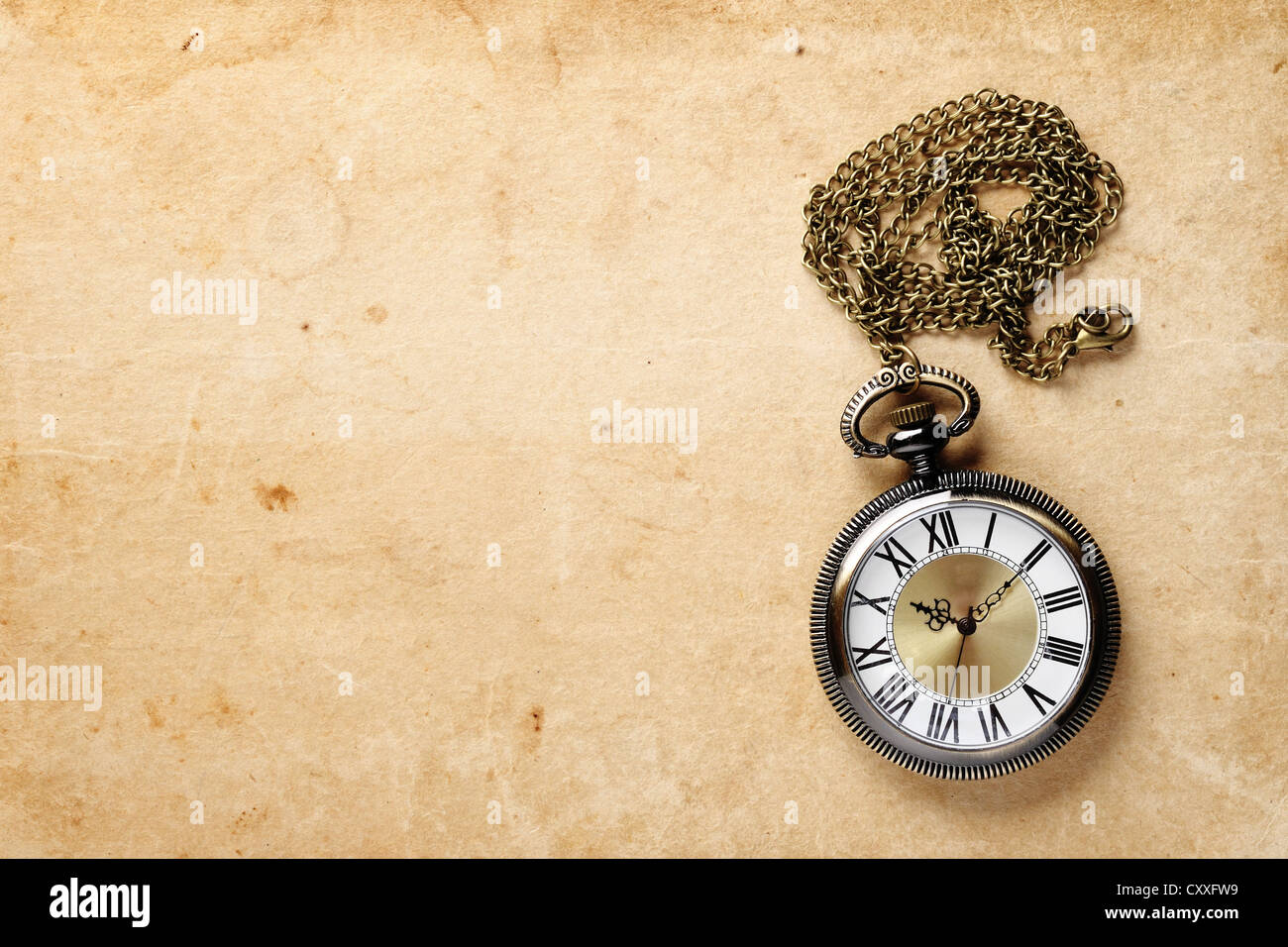 Vintage pocket watch on old paper Stock Photo - Alamy