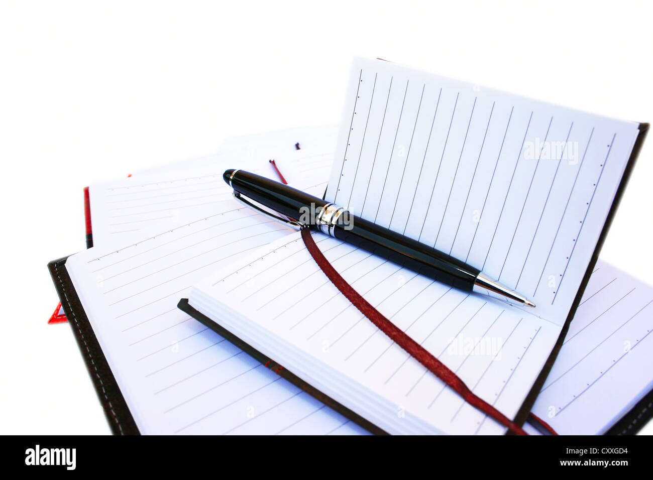 Pen and notebooks isolated on white background Stock Photo - Alamy