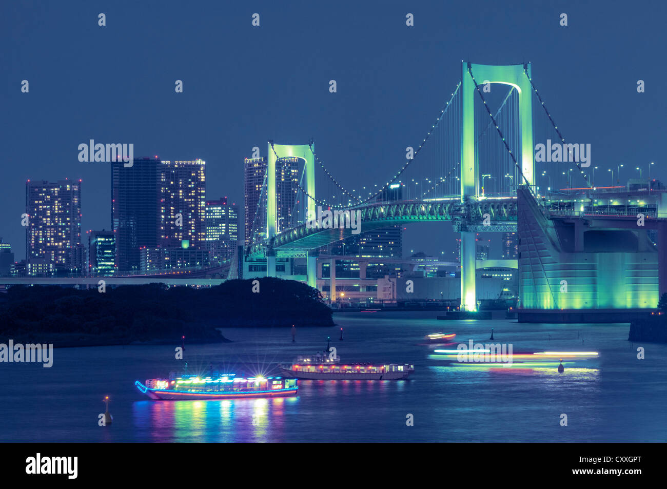 famous landmark, Tokyo Rainbow Bridge over bay waters with scenic night ...
