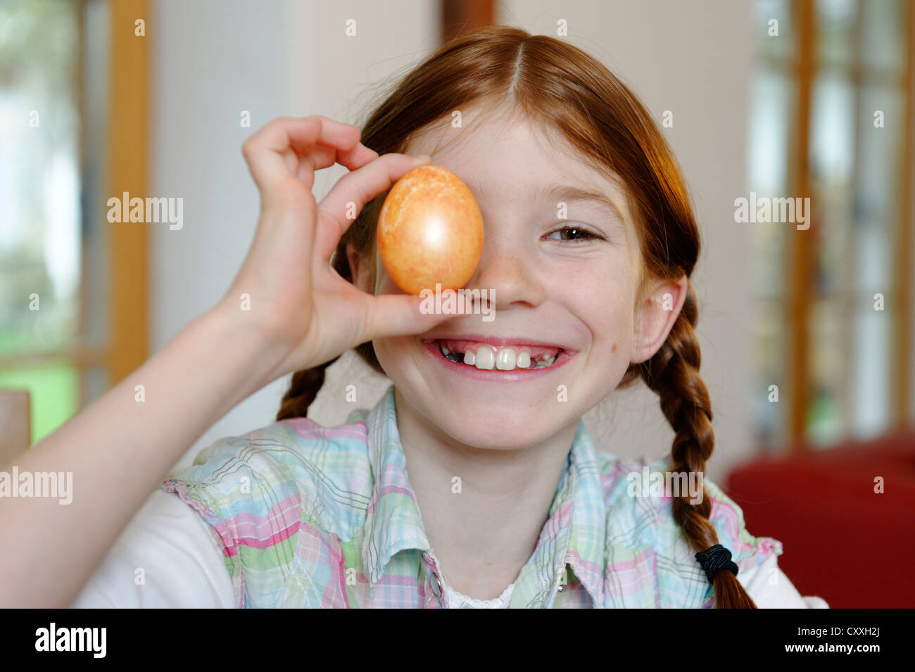 Child, girl holding a coloured Easter egg Stock Photo - Alamy