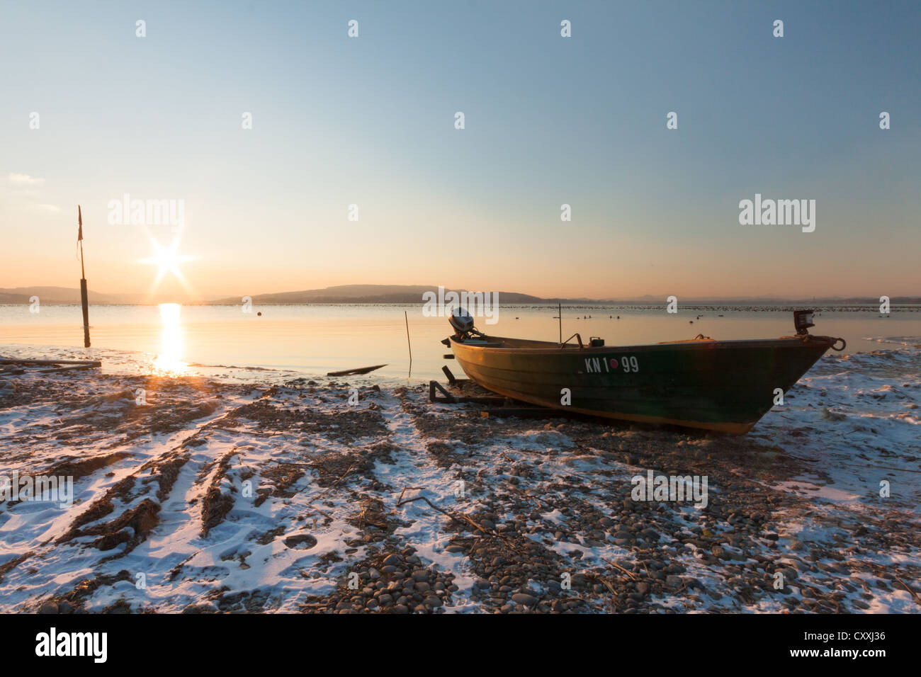Fishing boat on Lake Constance at sunset in winter, Reichenau Island ...