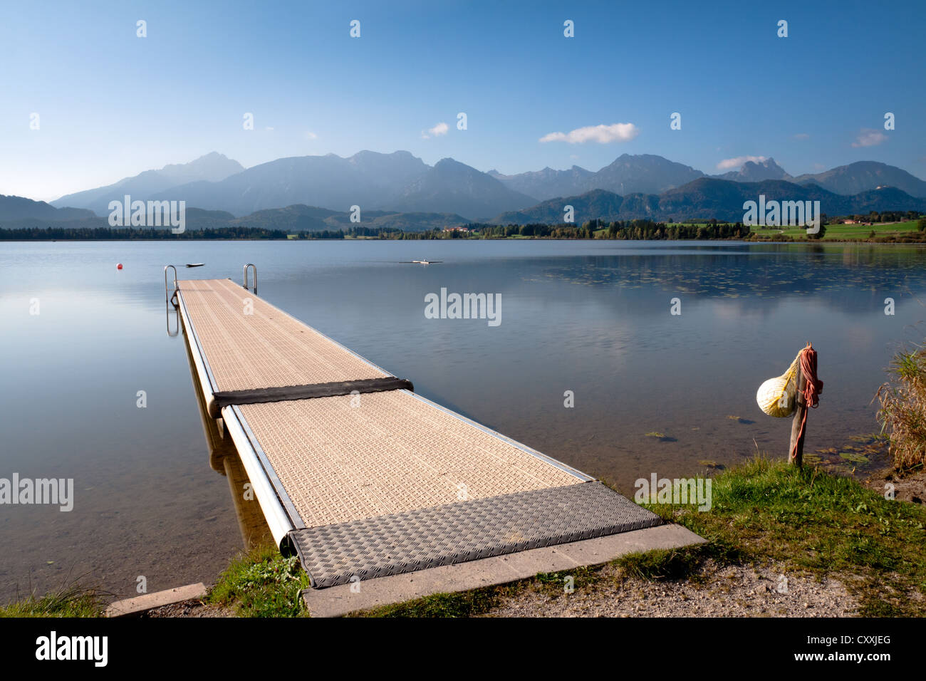 Jetty on lake Hopfensee, Allgaeu Alps at the back, Hopfen am See ...