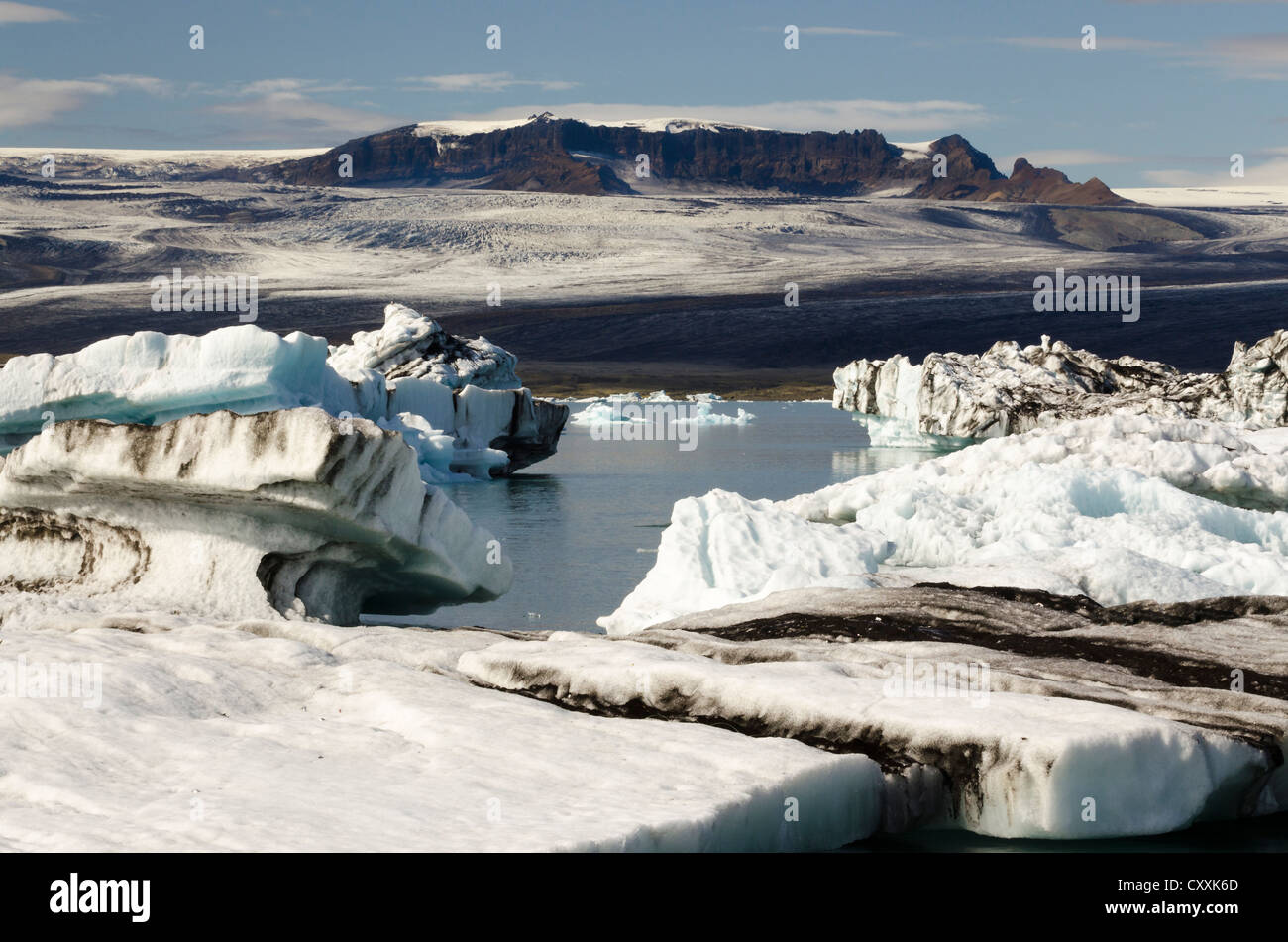 Partly black ash-coloured icebergs, glacier lagoon of Joekulsárlón ...