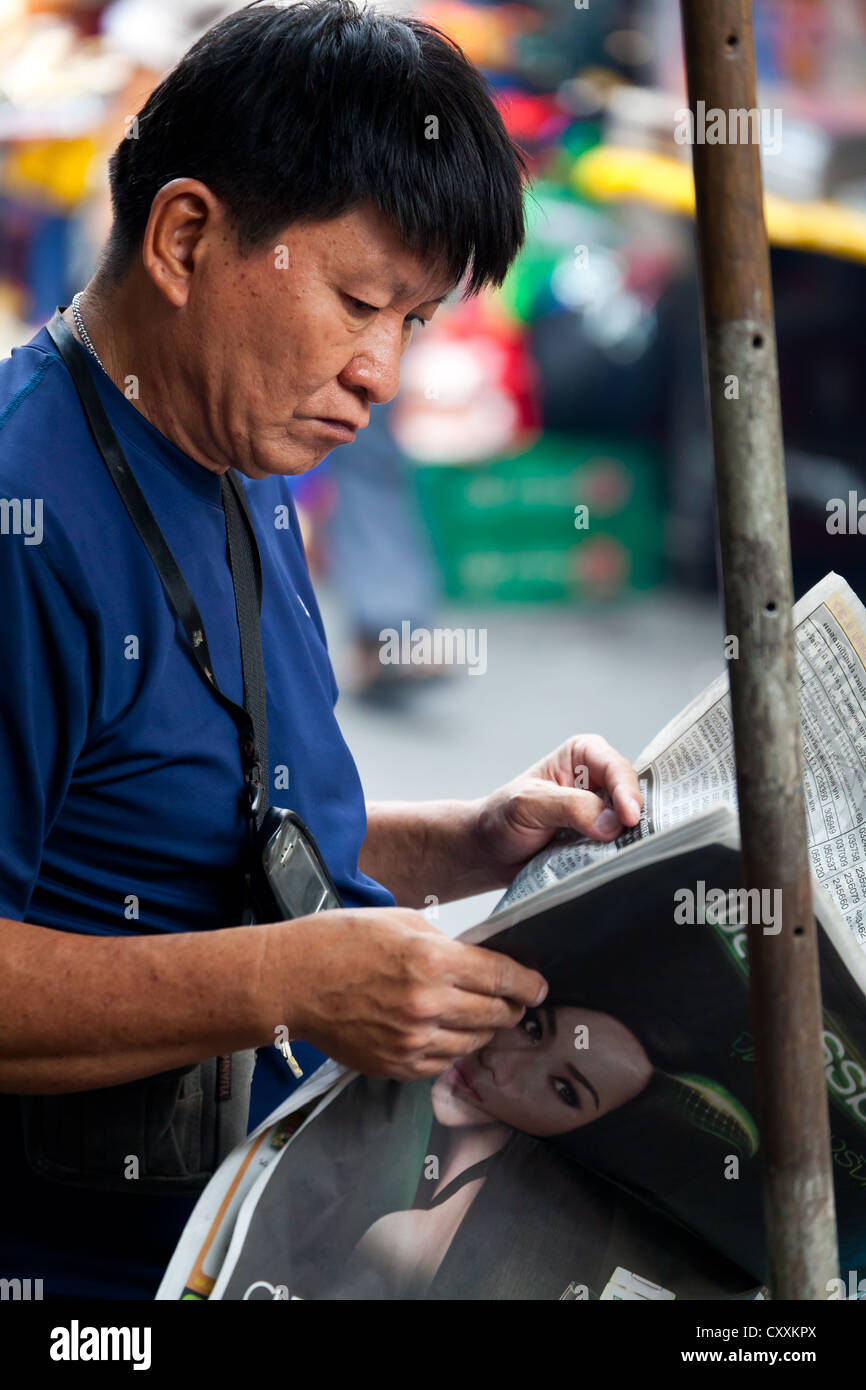 Thai man reading the newspaper hi-res stock photography and images - Alamy