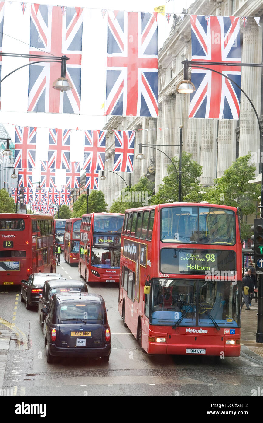 Traffic in the rain, double-decker buses on Oxford Street, Union Jack ...