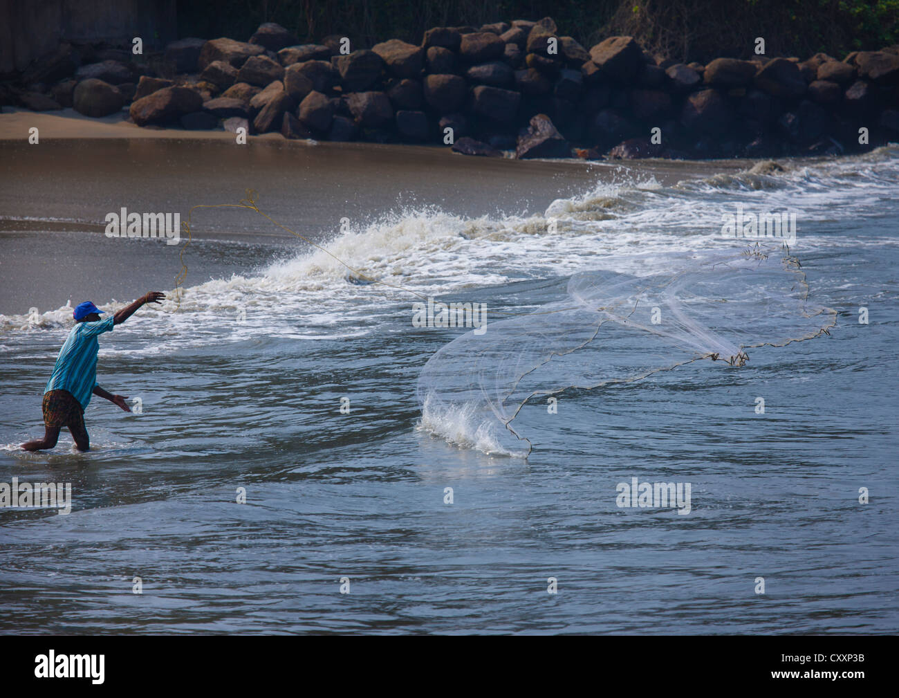 Fishermen Throwing His Nets To The Sea On The Beach, Kochi, India Stock ...
