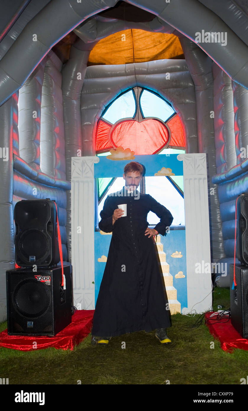 Mock priest in inflatable church, Electric Picnic 2012 Stock Photo - Alamy