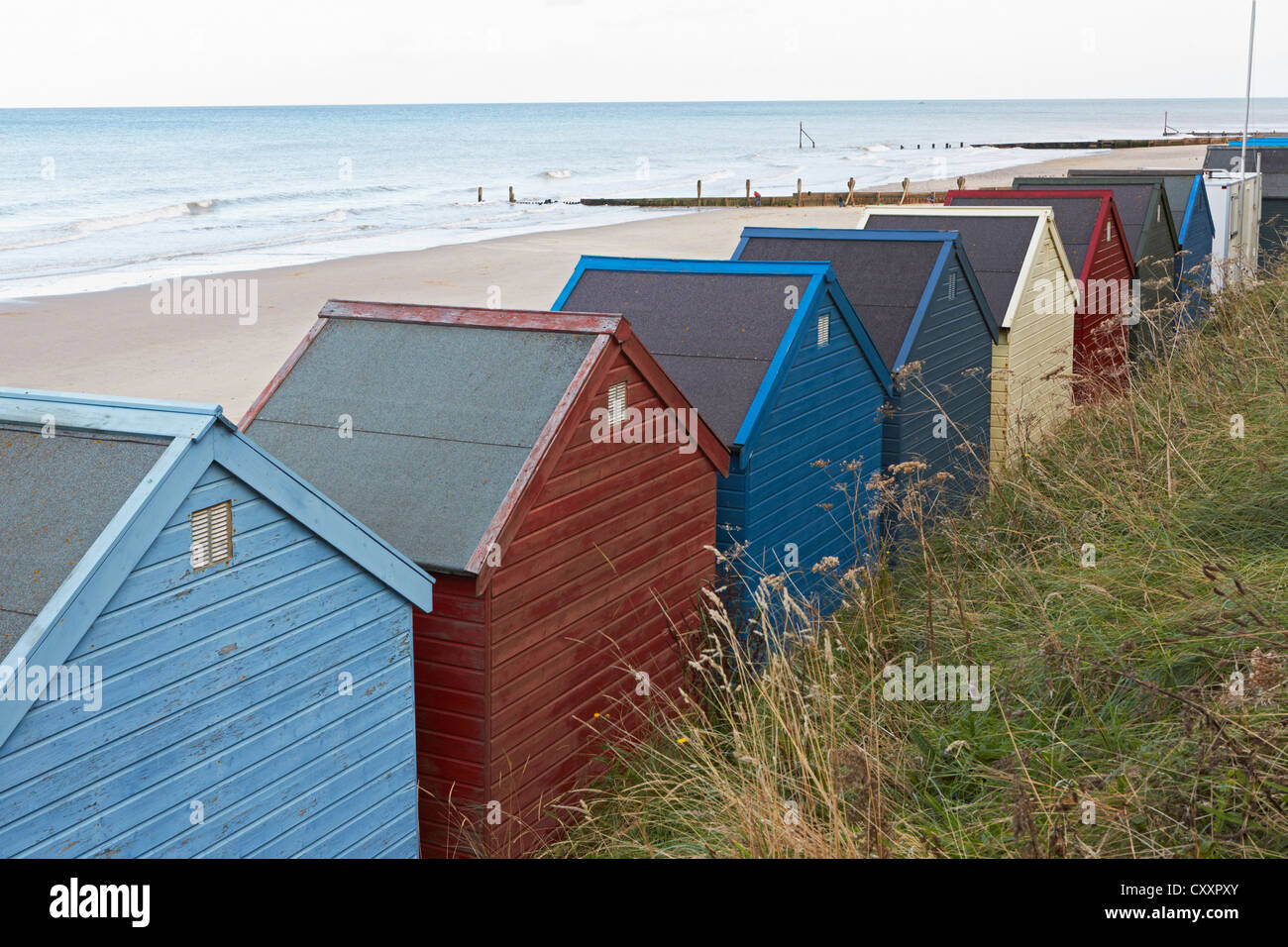 North Norfolk Mundesley multi coloured beach huts on the sea wall Stock ...