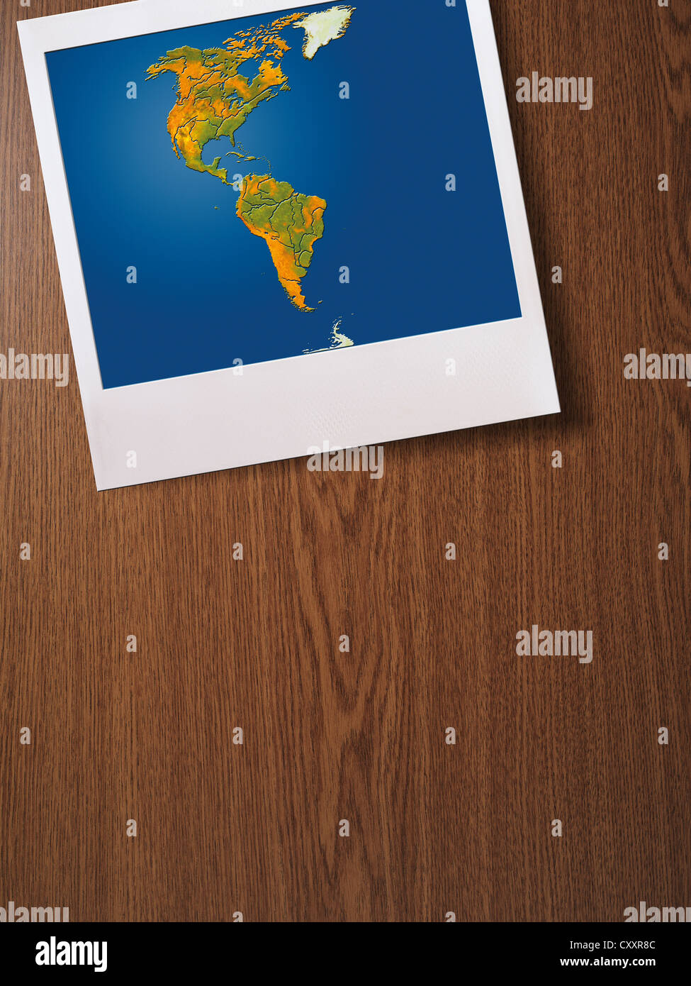 Polaroid photo with a map of North America and South America hanging on ...