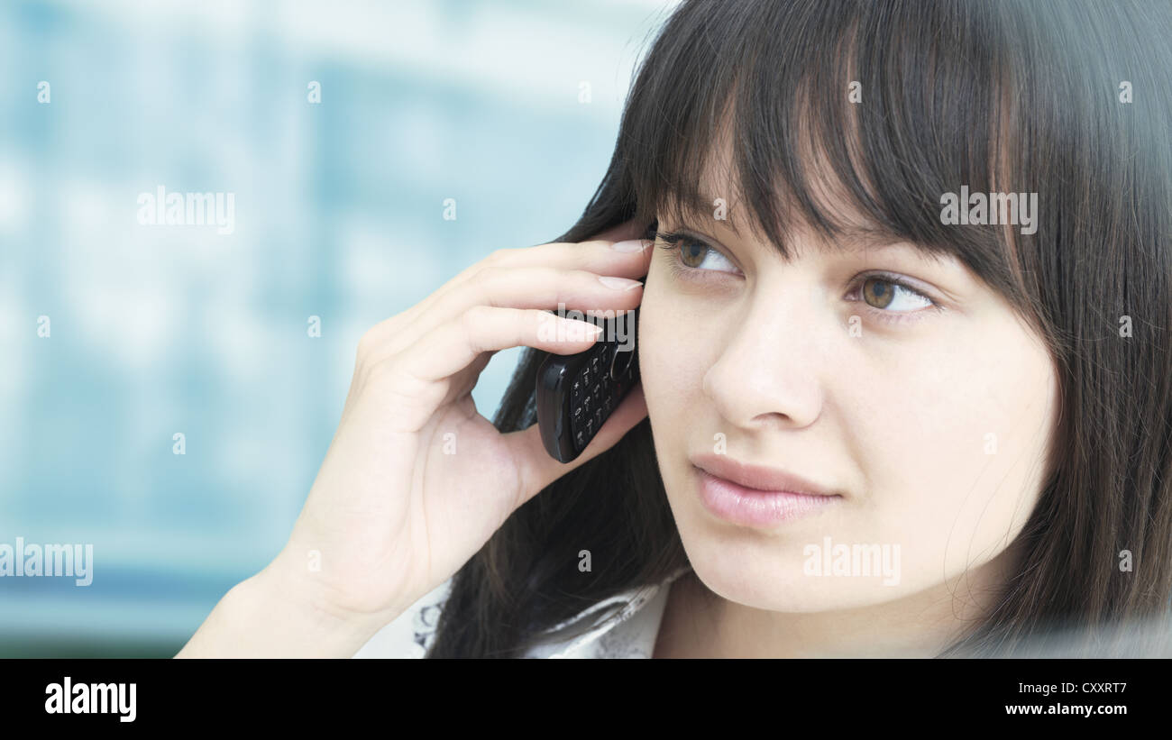 Young woman speaking on a mobile phone Stock Photo - Alamy