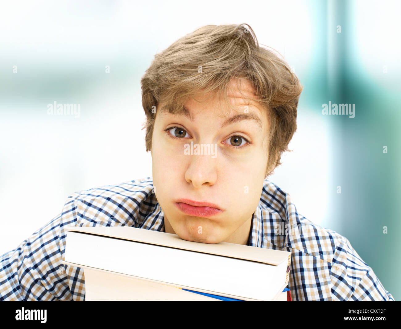 Overworked student with a stacks of books Stock Photo - Alamy