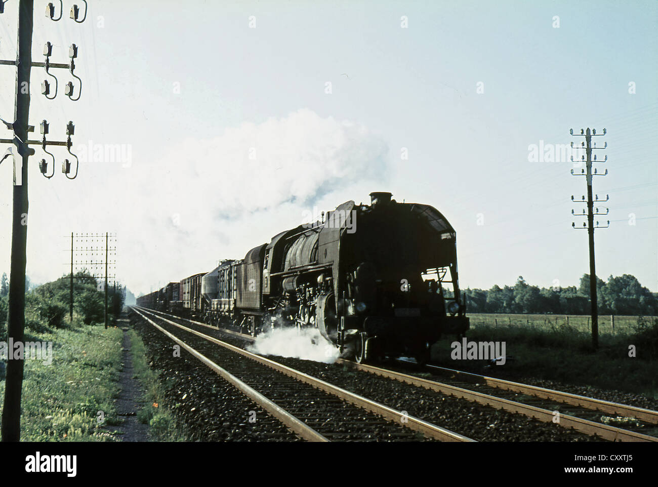 An American built SNCF 141R 2-8-2 rolls through the French countryside ...
