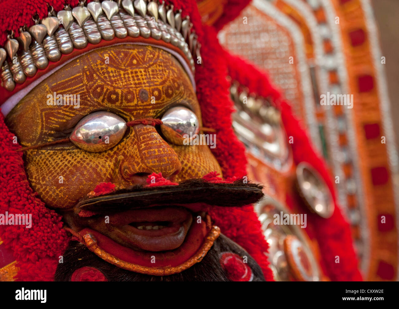 Man Dressed For Theyyam Ceremony With Traditional Painting On His Face ...
