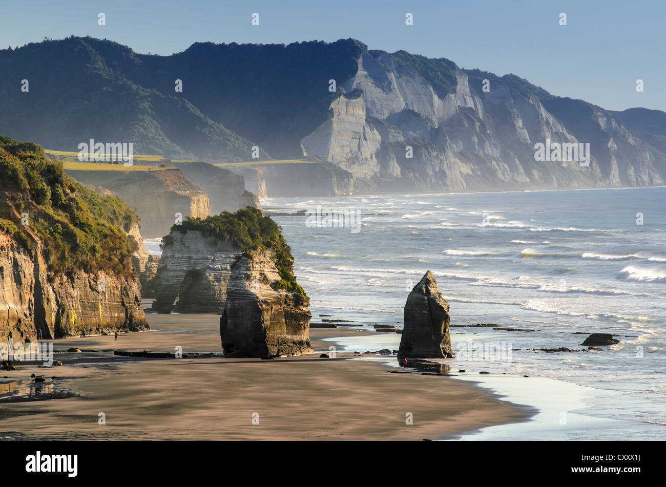 White Cliffs Beach at low tide, rocks in the surf, Ahititi, Taranaki ...
