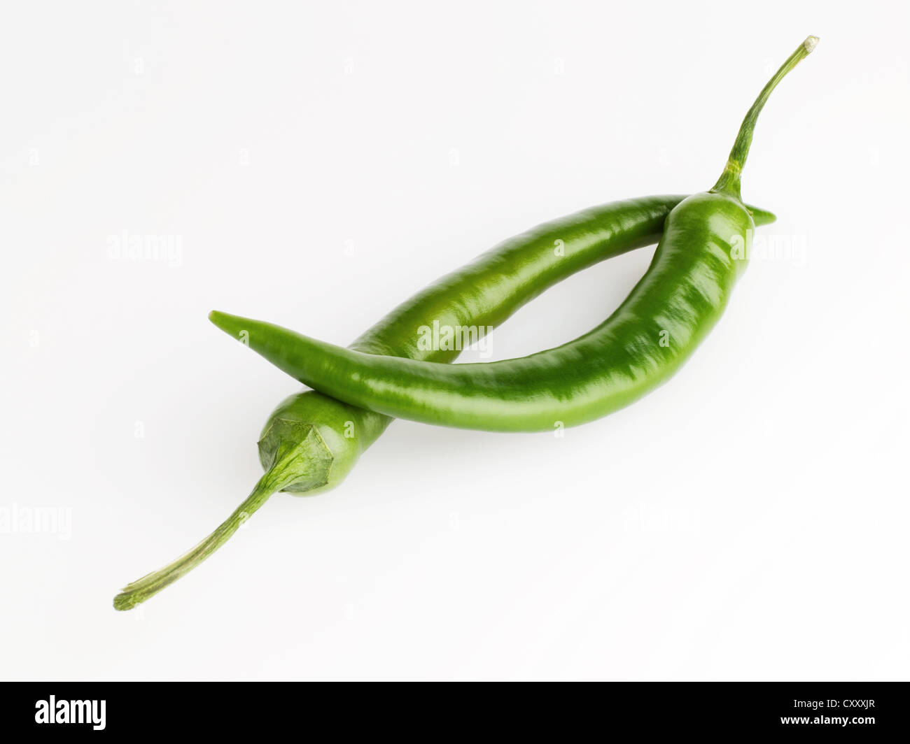 Two green pepperoni on white background Stock Photo - Alamy