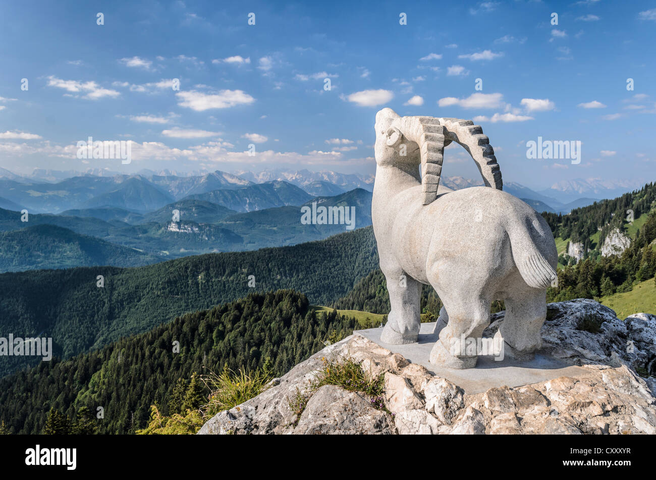 Statue of an ibex in front of the mountain ranges of the Karwendel ...